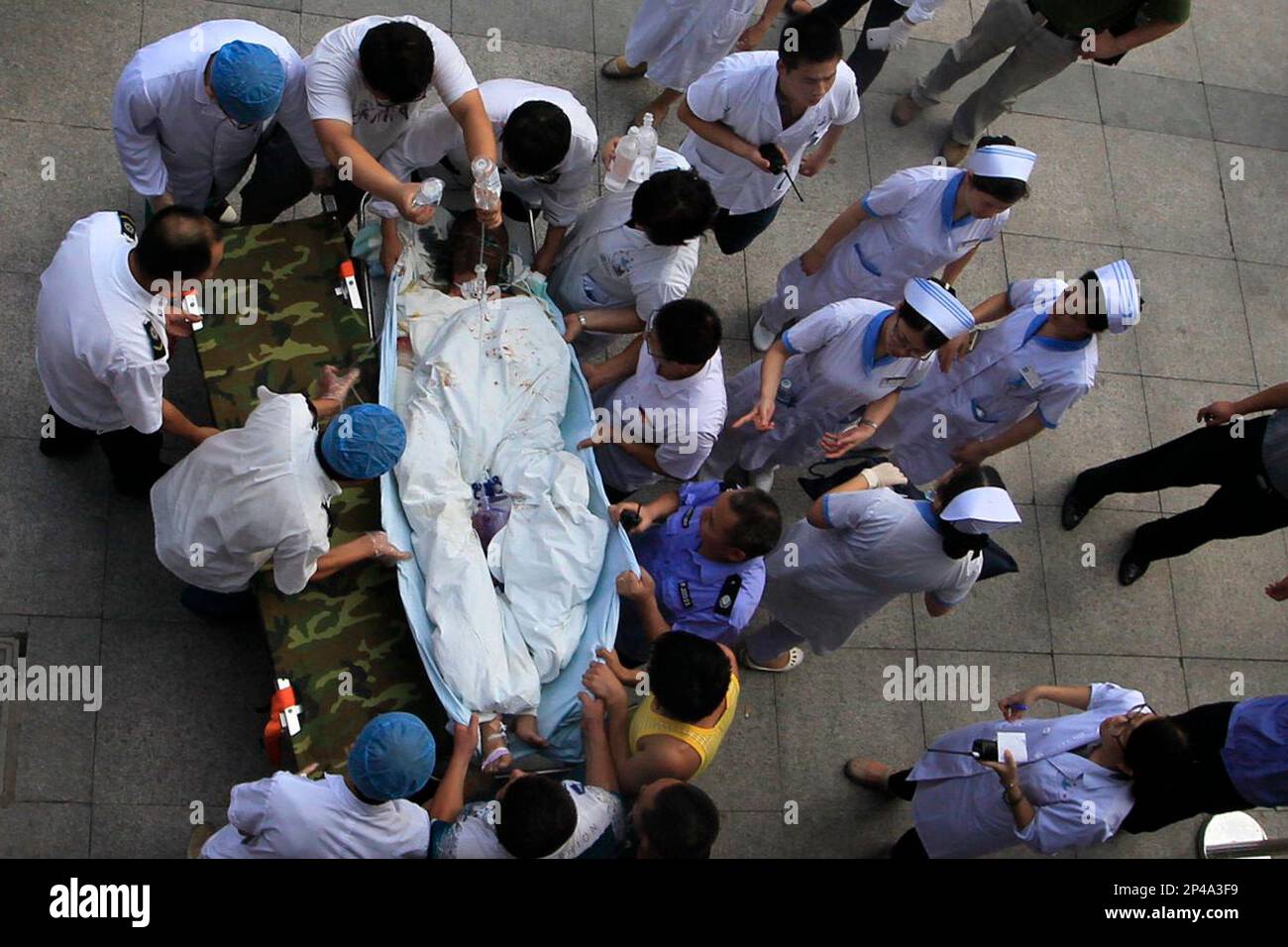 Medical staff move a severely burnt victim of an explosion at an ...