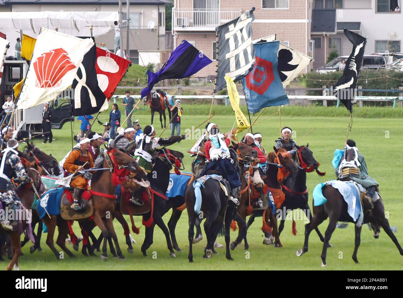 Samurai horseback riders clad in armor participate in the ...