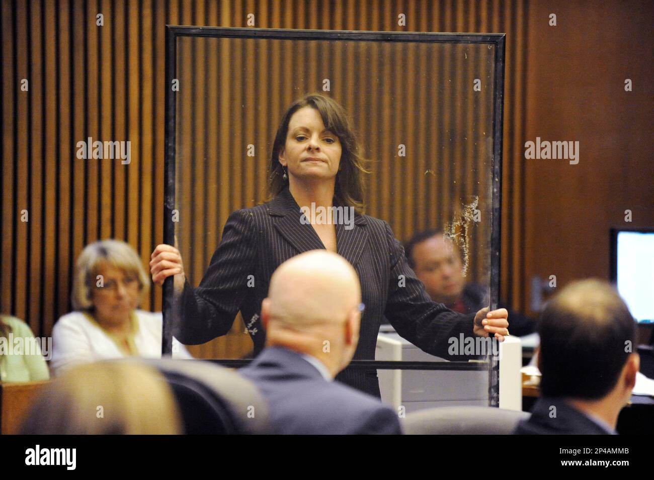 Defense attorney Cheryl Carpenter holds the front-door screen from Theodore Wafer's home, during ...