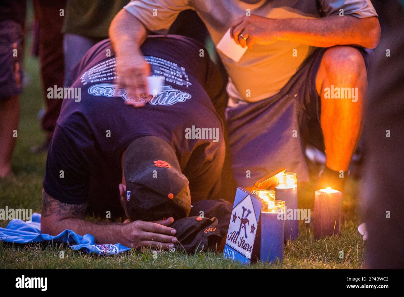 Kris Frost mourns for his son during a candlelight vigil honoring the ...