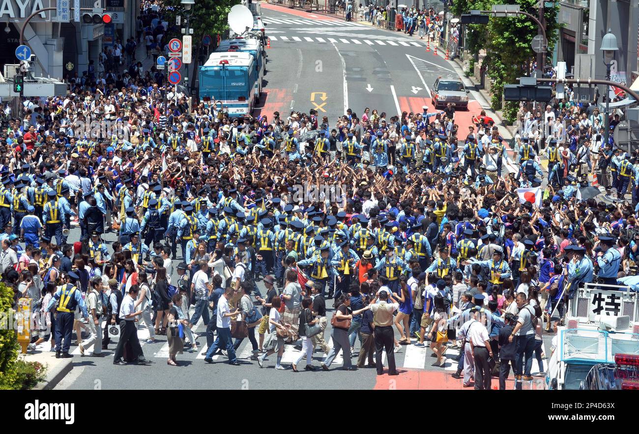 Supporters of Japanese national squad, Samurai Blue cheer at a scramble ...