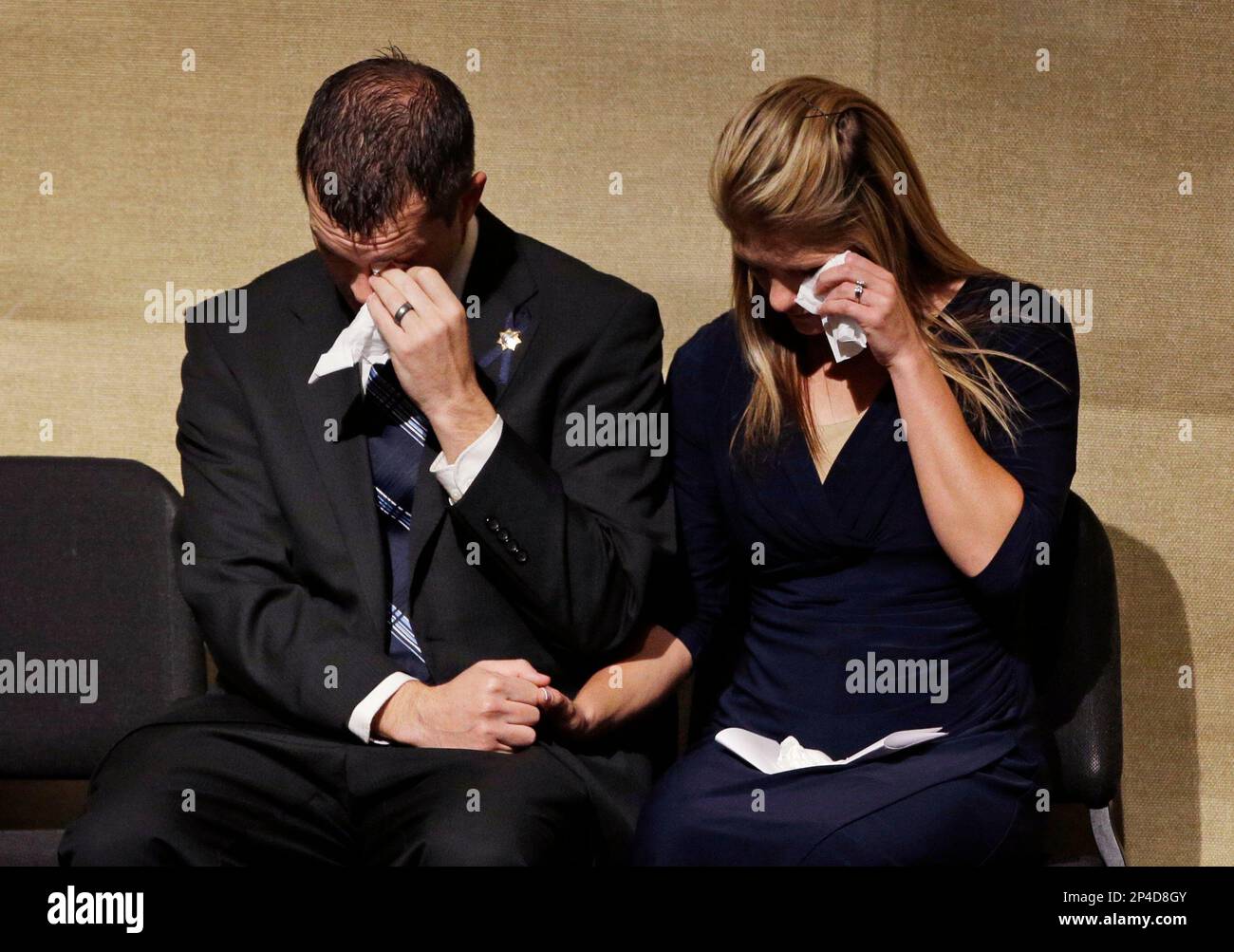 Joseph Beck, left, and Elizabeth Krmpotich wipe tears from their eyes ...