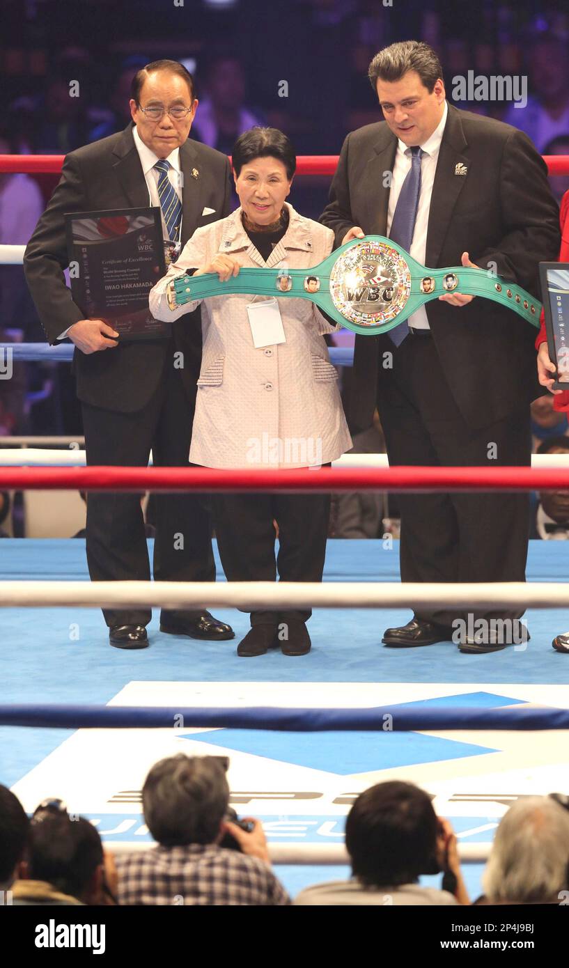 Hideko Hakamada (C) poses after receiving an honorary championship belt ...