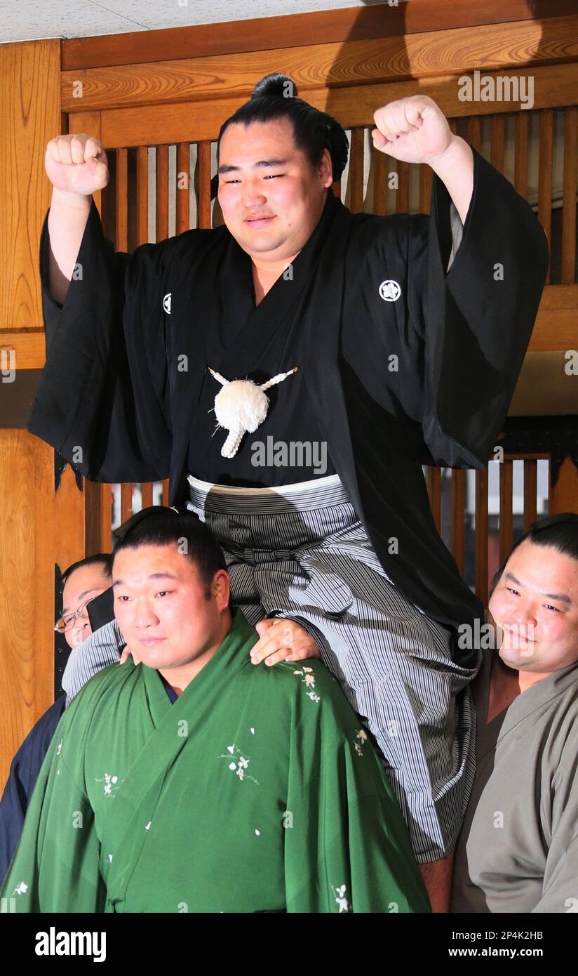Mongolian Kakuryu (C) rides his stable fellow wrestlers' shoulders in ...