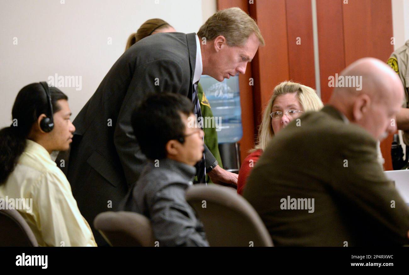 Defense lawyer Scott Peterson, center, talks with members of the ...