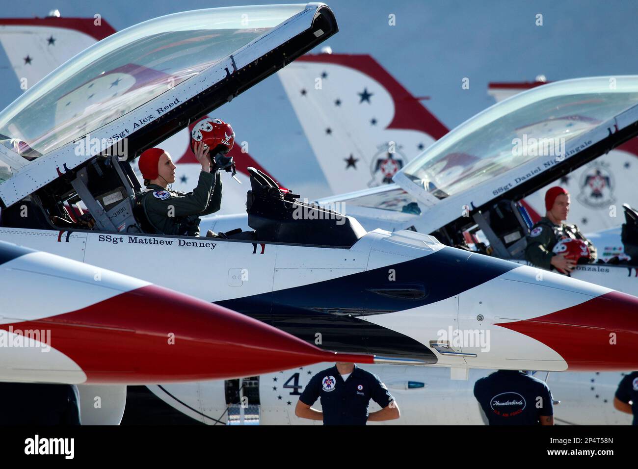 Thunderbird pilot Maj. Caroline Jensen puts on her helmut in the ...