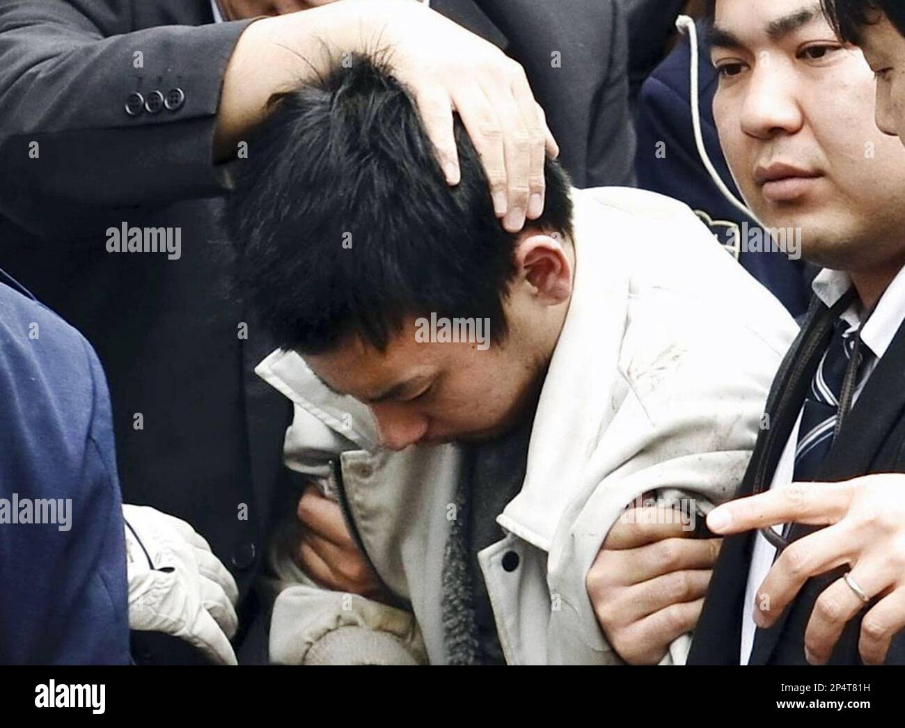 Rape suspect Yuta Sugimoto, center, is taken in the Kawasaki branch of ...