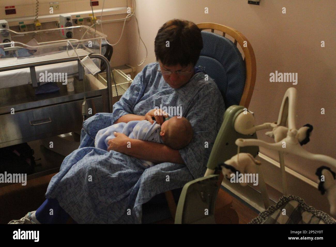Pat Blumenberg, a registered nurse, rocks a drug addicted two-month-old ...