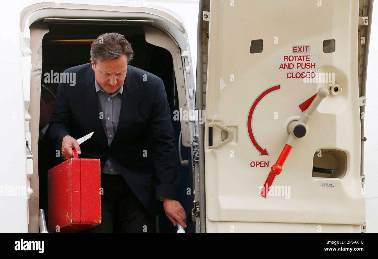 Britain's Prime Minister David Cameron steps off of his plane as he ...