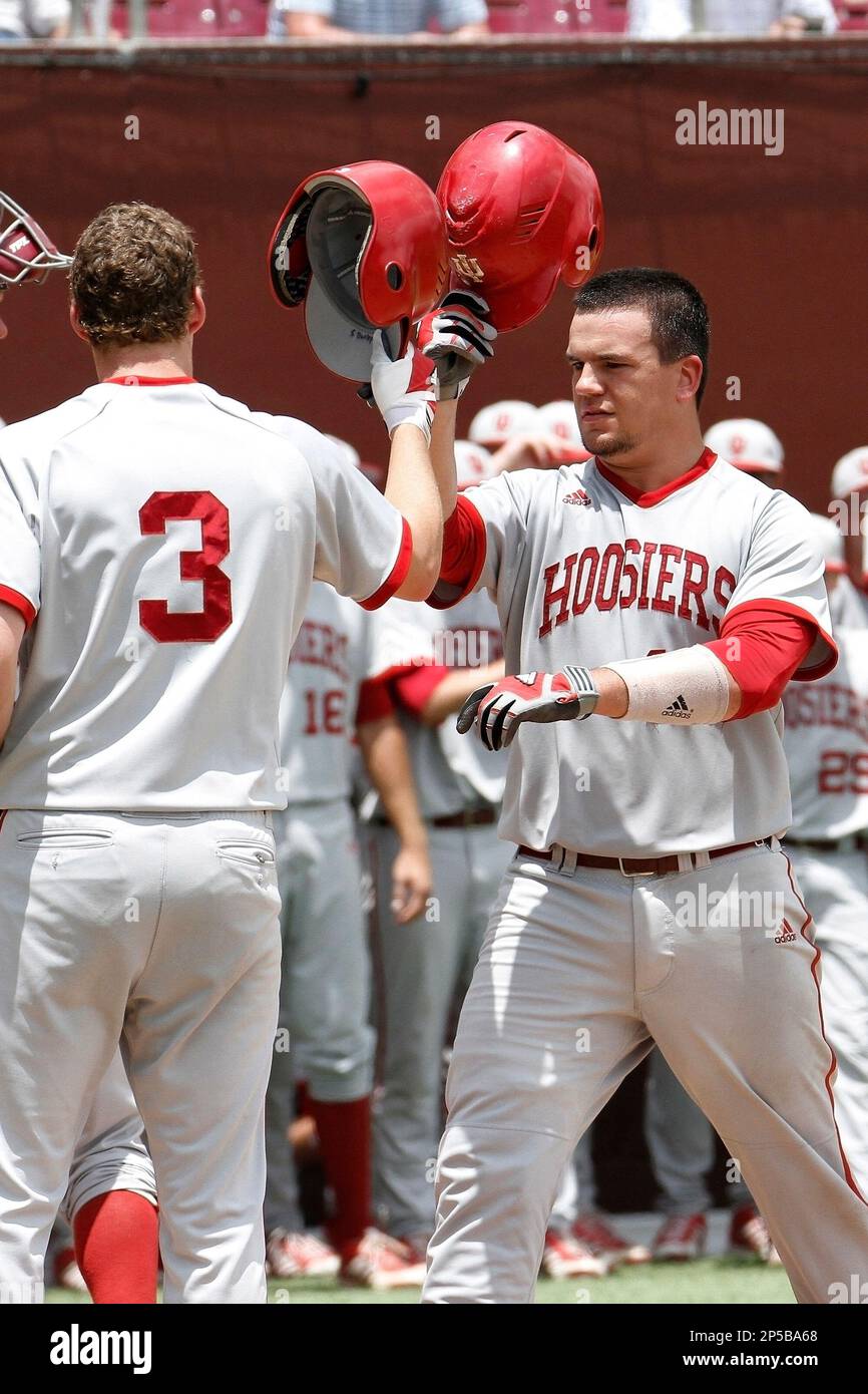 Indiana catcher (10) Kyle Schwarber is greeted at home plate by ...