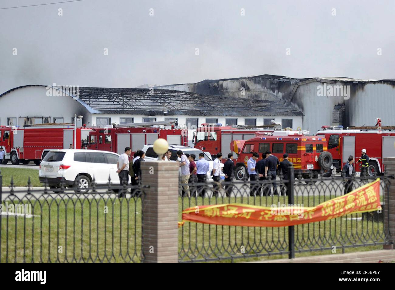 Firemen and investigators work at the site of a fire caused by an ...