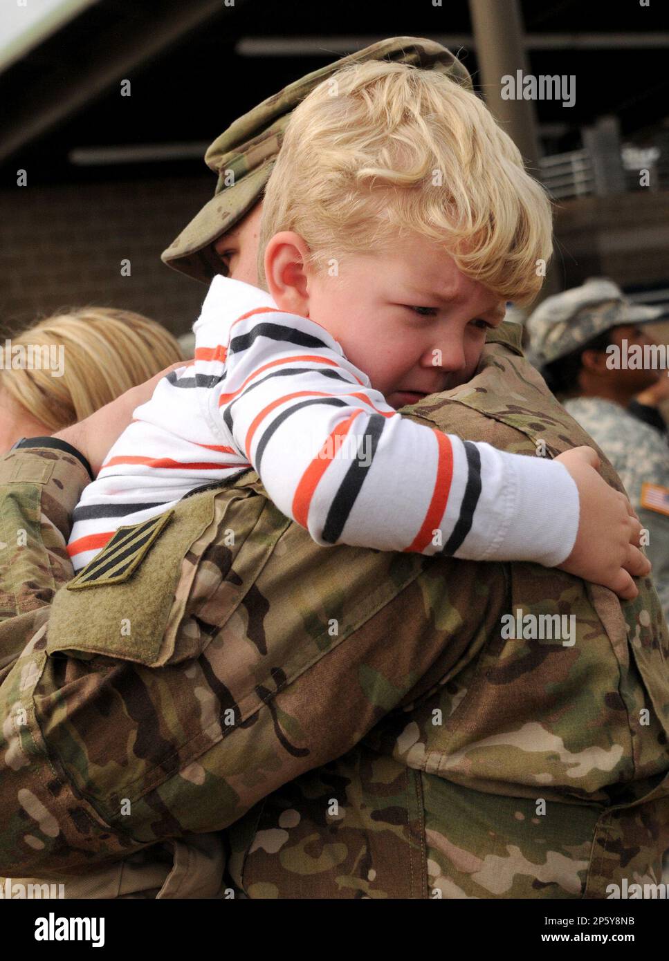 Three-year-old Cain Mullins is emotional as he hugs his father, Army ...