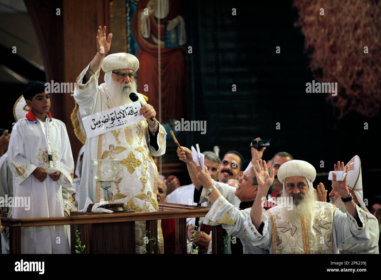 Acting Coptic Pope Pachomios, center, displays the name of 60-year-old ...