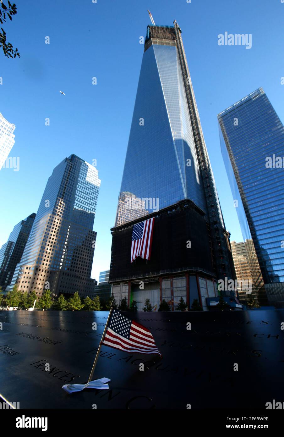 An American flag is paced in one of the names of the victims of the ...
