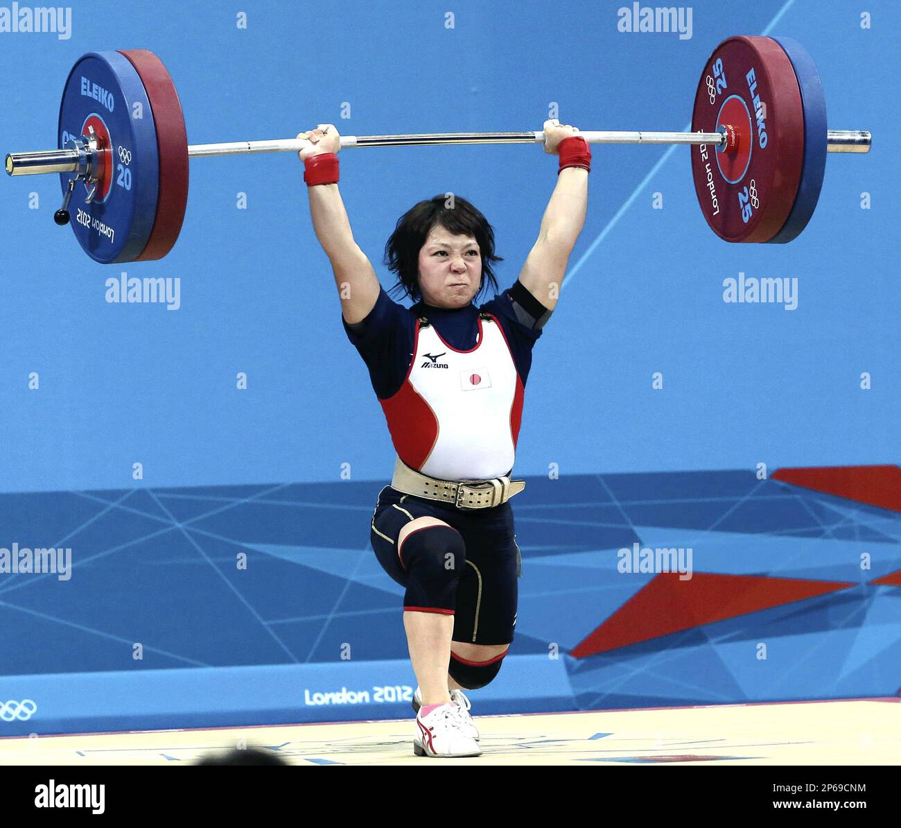 Hiromi Miyake of Japan lifts 110 kilograms in the clean and jerk of the Olympic women's 48-kg ...