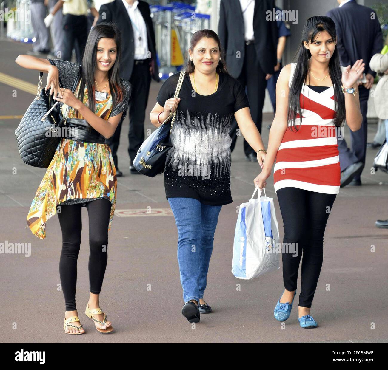 Radha Mainali (C), the wife of Govinda Prasad Mainali, her daughters ...