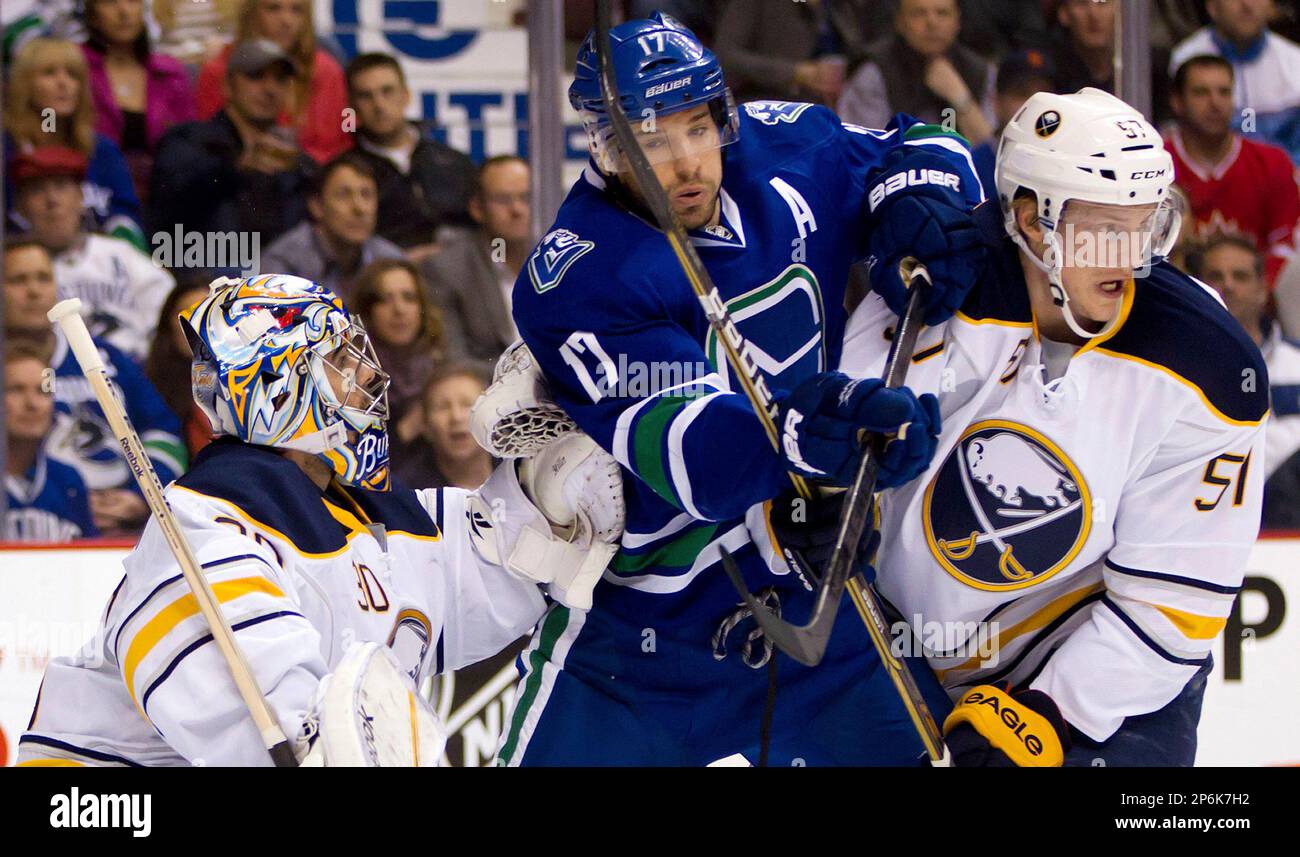 Vancouver Canucks' Ryan Kesler, center, fights between Buffalo Sabres ...
