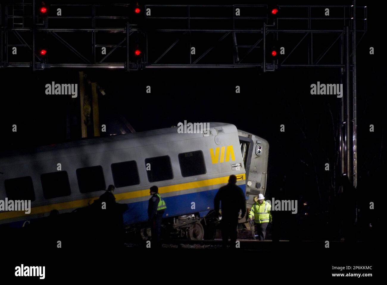 Crews work to remove a derailed Via Rail passenger train from the ...