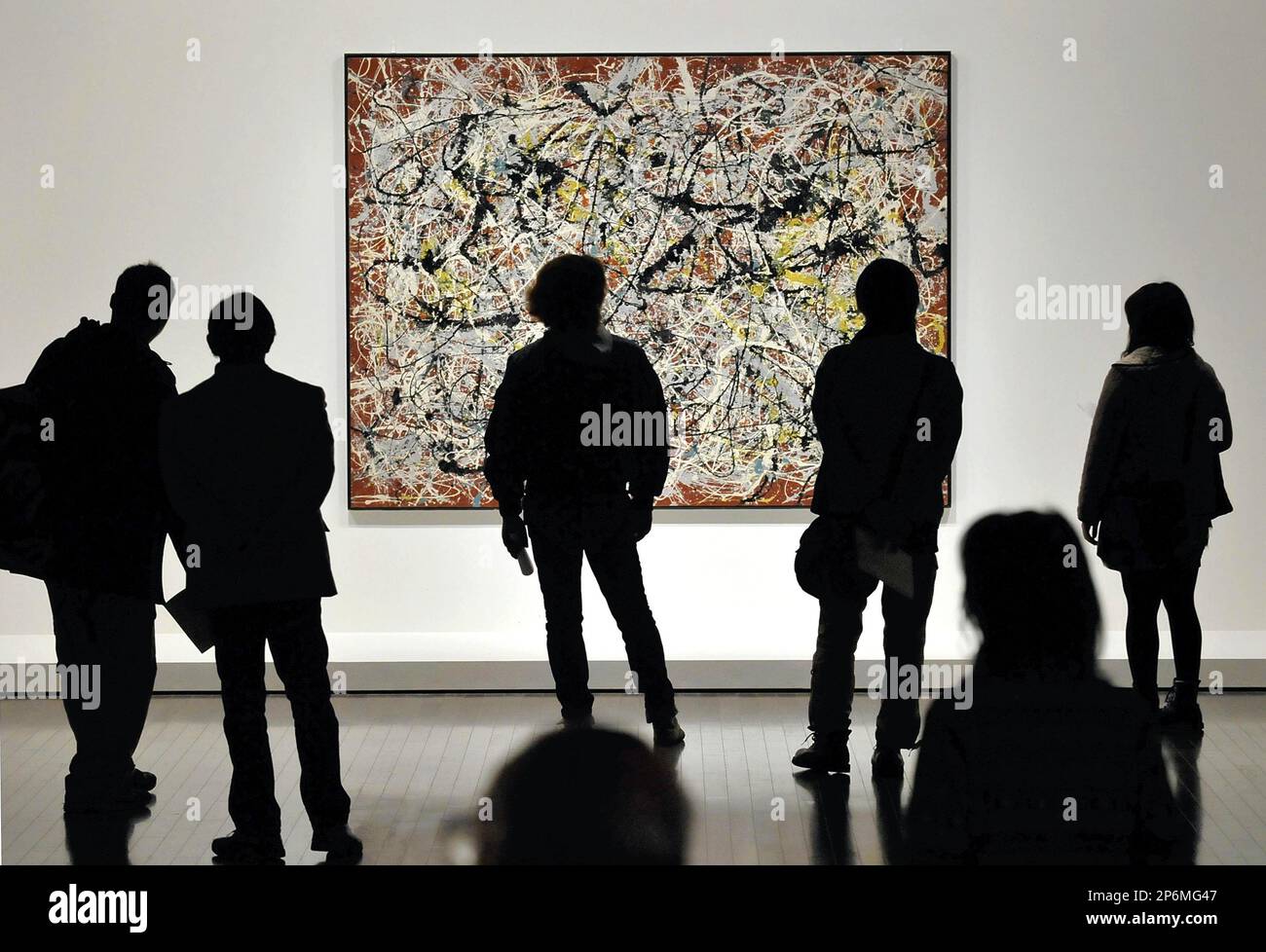 Visitors admire a Jackson Pollock's masterpiece “Mural on Indian Red Ground”, which was painted ...