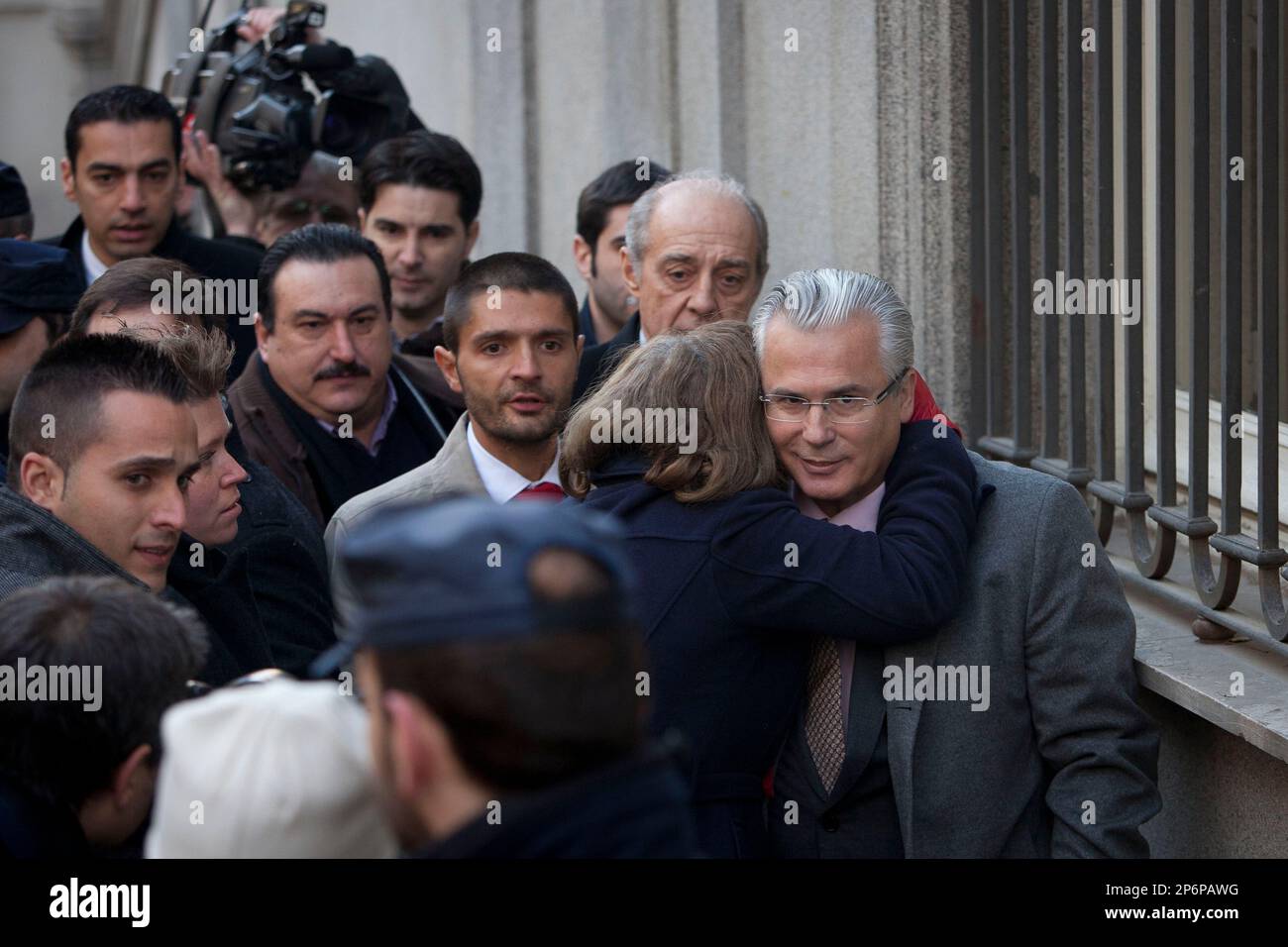 A unidentified woman embraces Spanish judge Baltazar Garzon as he ...