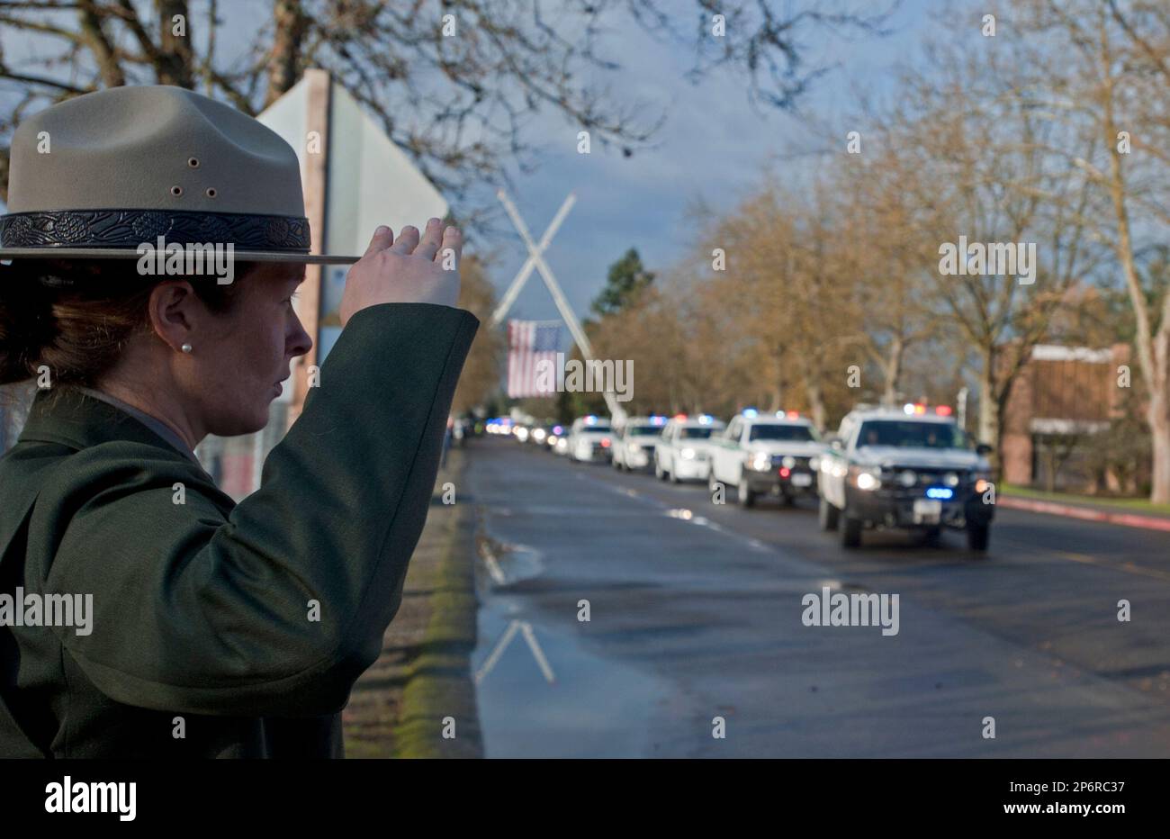 National Parks Service ranger Lauren Newman salutes as a procession of ...