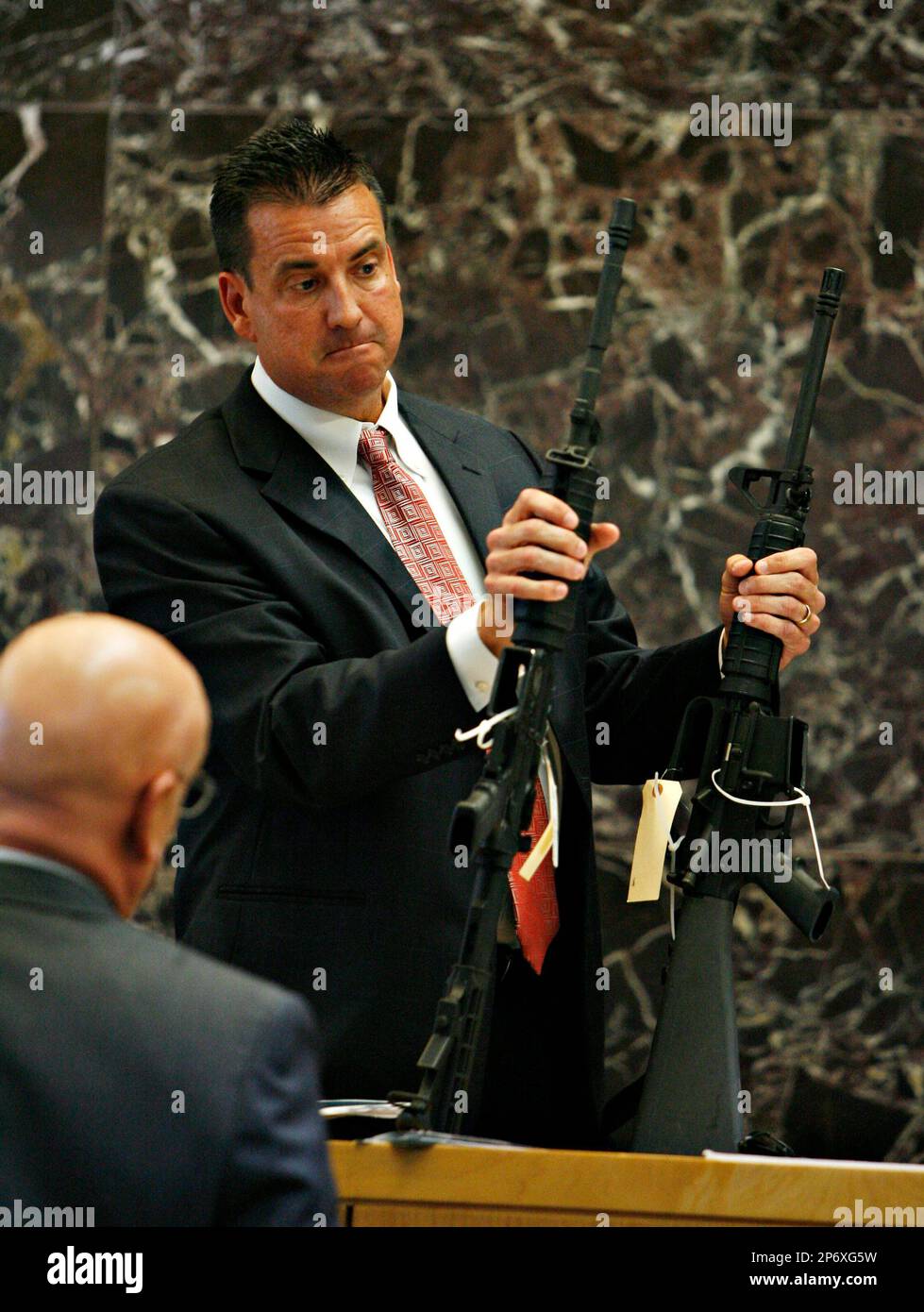 Assistant State Attorney Richard Ripplinger, left, watches after ...
