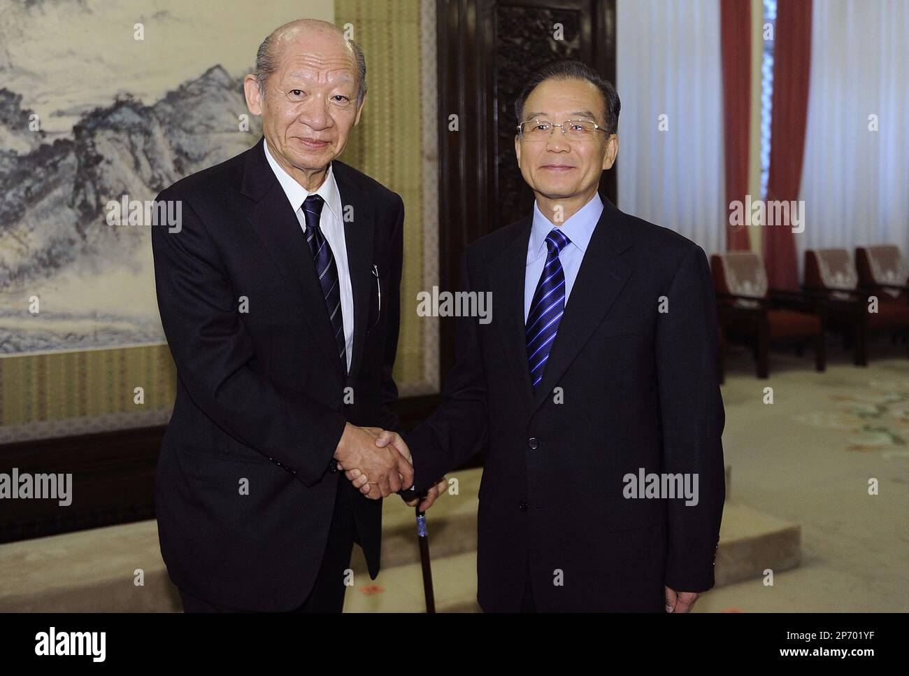 Chinese Premier Wen Jiabao shakes hands with Taizo Nishimuro (L), the ...