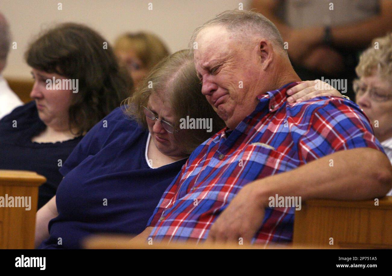 Roger Myer, right, hugs his daughter Mandy, center, with other daughter ...