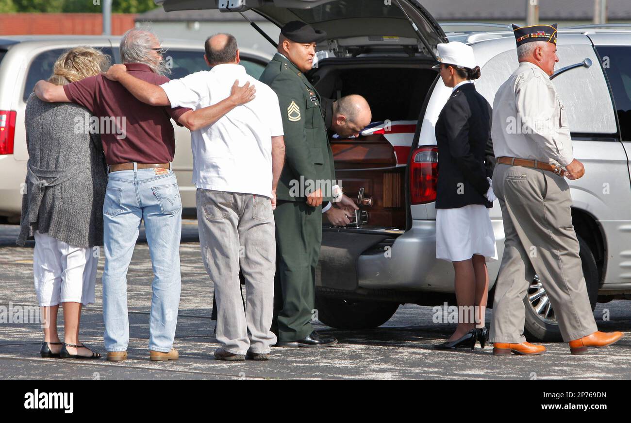 Lance Allers, center, hugs his wife, Denise, left, and brother Bryan as ...