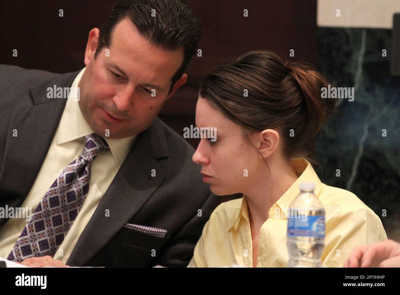 Defense attorney Jose Baez, left, talks with his client Casey Anthony ...