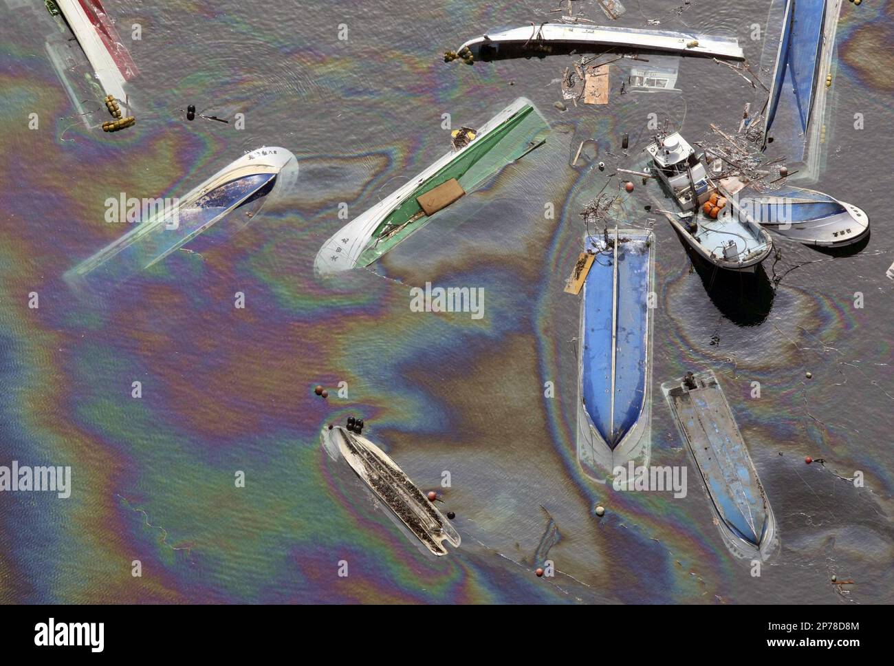 Vessels float on oil spilled water in Fudai, Iwate, northern Japan ...
