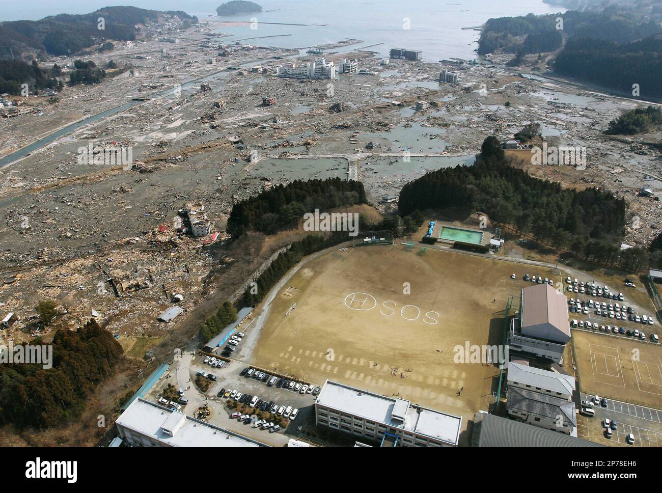 An SOS sign is written on the ground of Shizugawa High School in ...