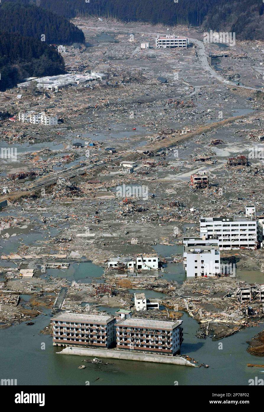 Rubble is scattered across the wide areas of the town of Minami Sanriku ...