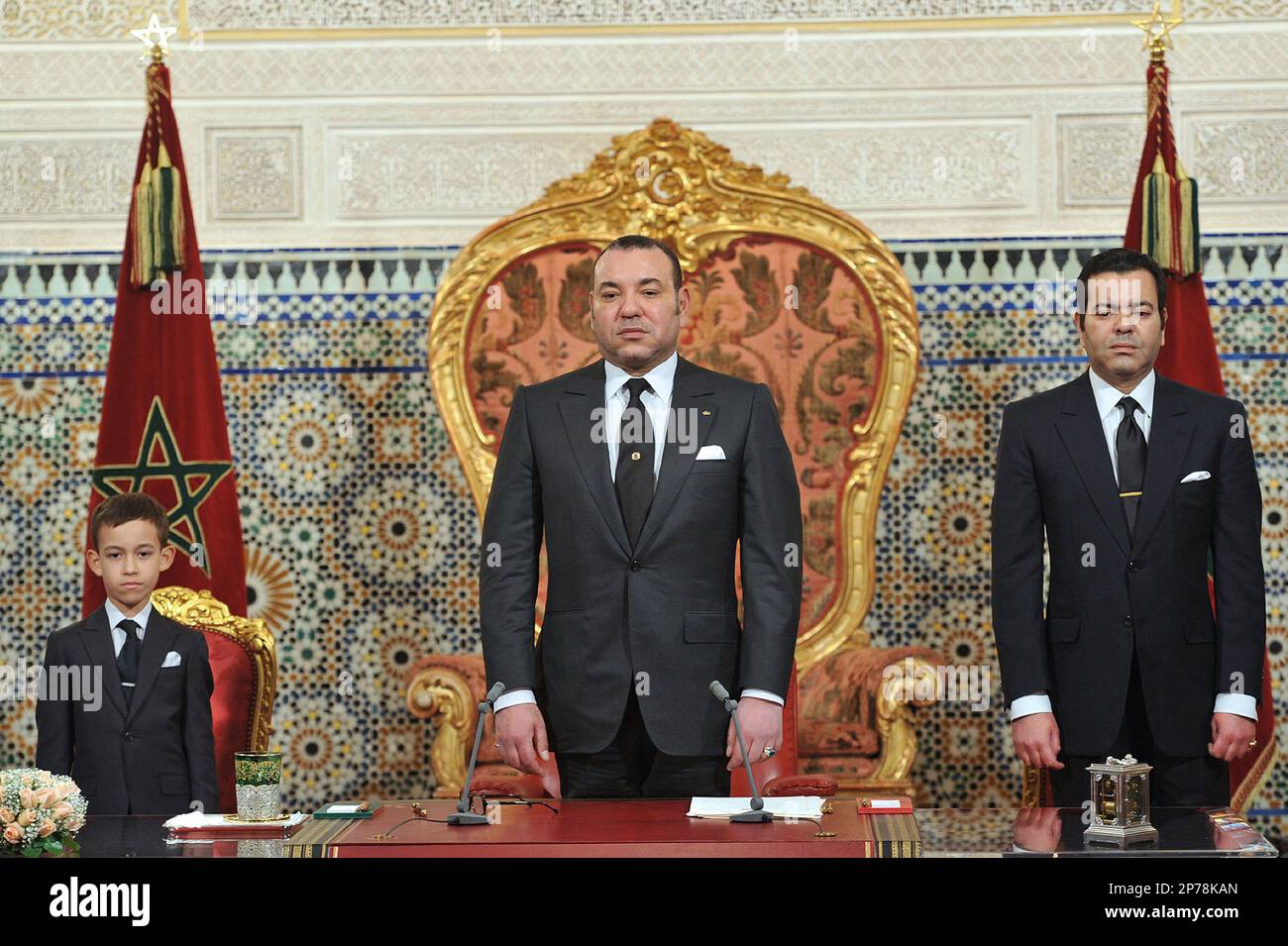 In this photo released by the Royal Palace, Morocco's King Mohammed VI flanked by his son Moulay ...