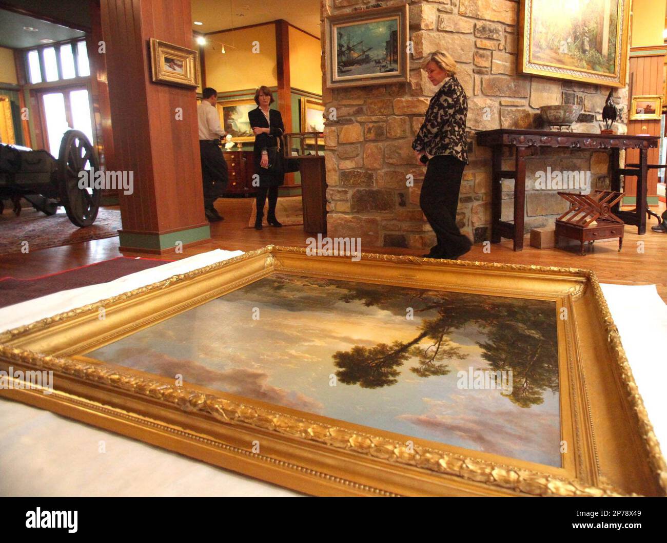 Museum executive director Susan Austin-Warner, right, looks over one of ...