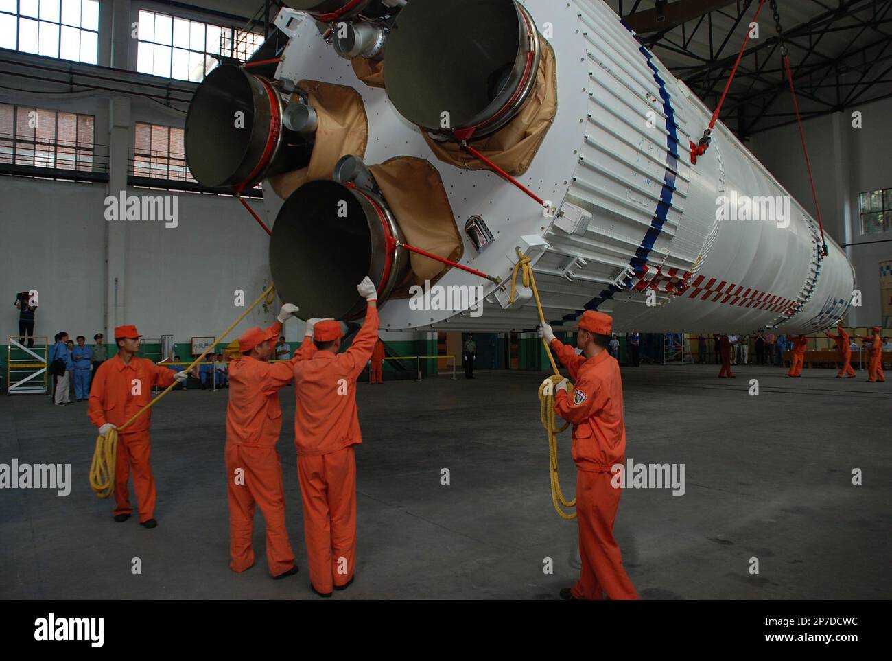Workers install the Long March 3C rocket, which will boost the unmanned ...