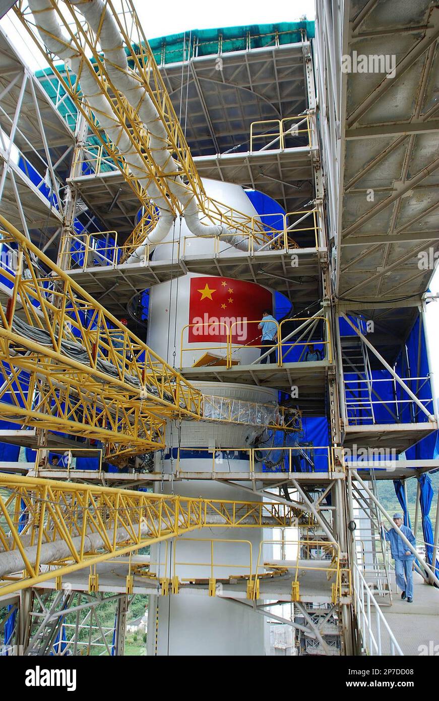 Workers install the Long March 3C rocket, which will boost the unmanned ...
