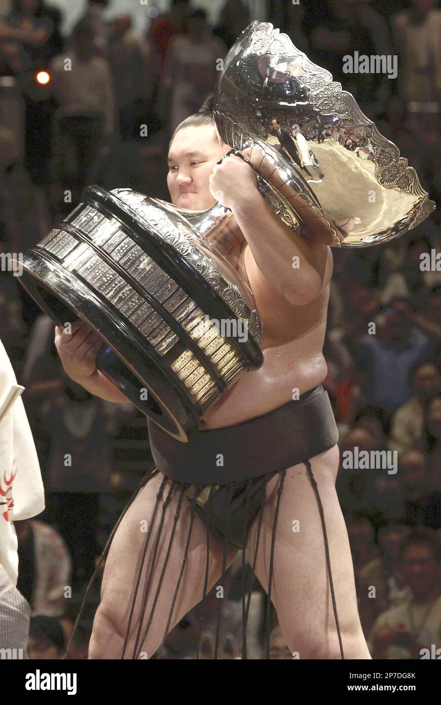 Yokozuna Hakuho holds the Emperor's Cup tightly, after conquering the ...