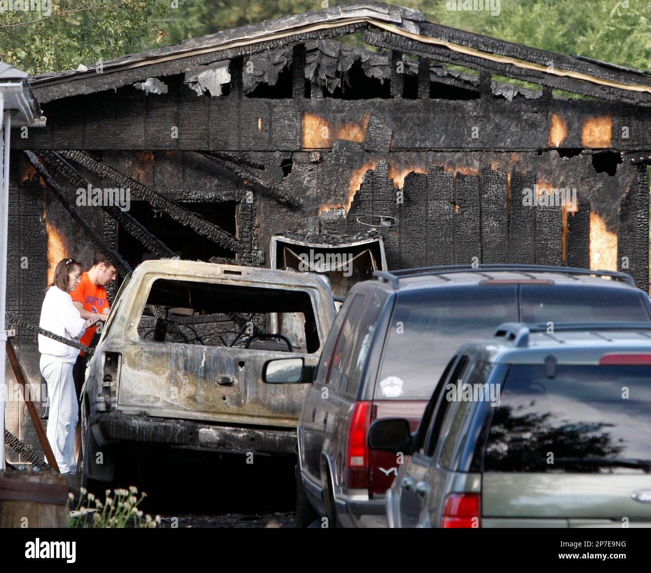 Jill Ragan, Boise, Idaho, and her son Nathan Ragan survey the damage ...