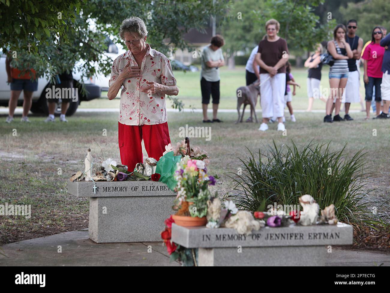 Rose Rogers says a prayer at the memorial for Jennifer Ertman and ...