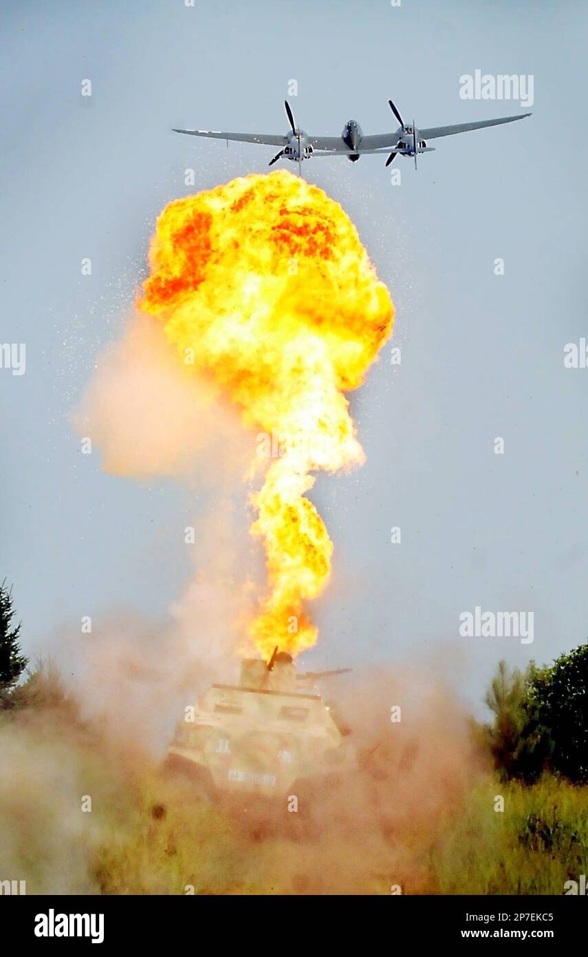 Pyrotechnics send up a fireball in the wake of a strafing run of a WWII ...