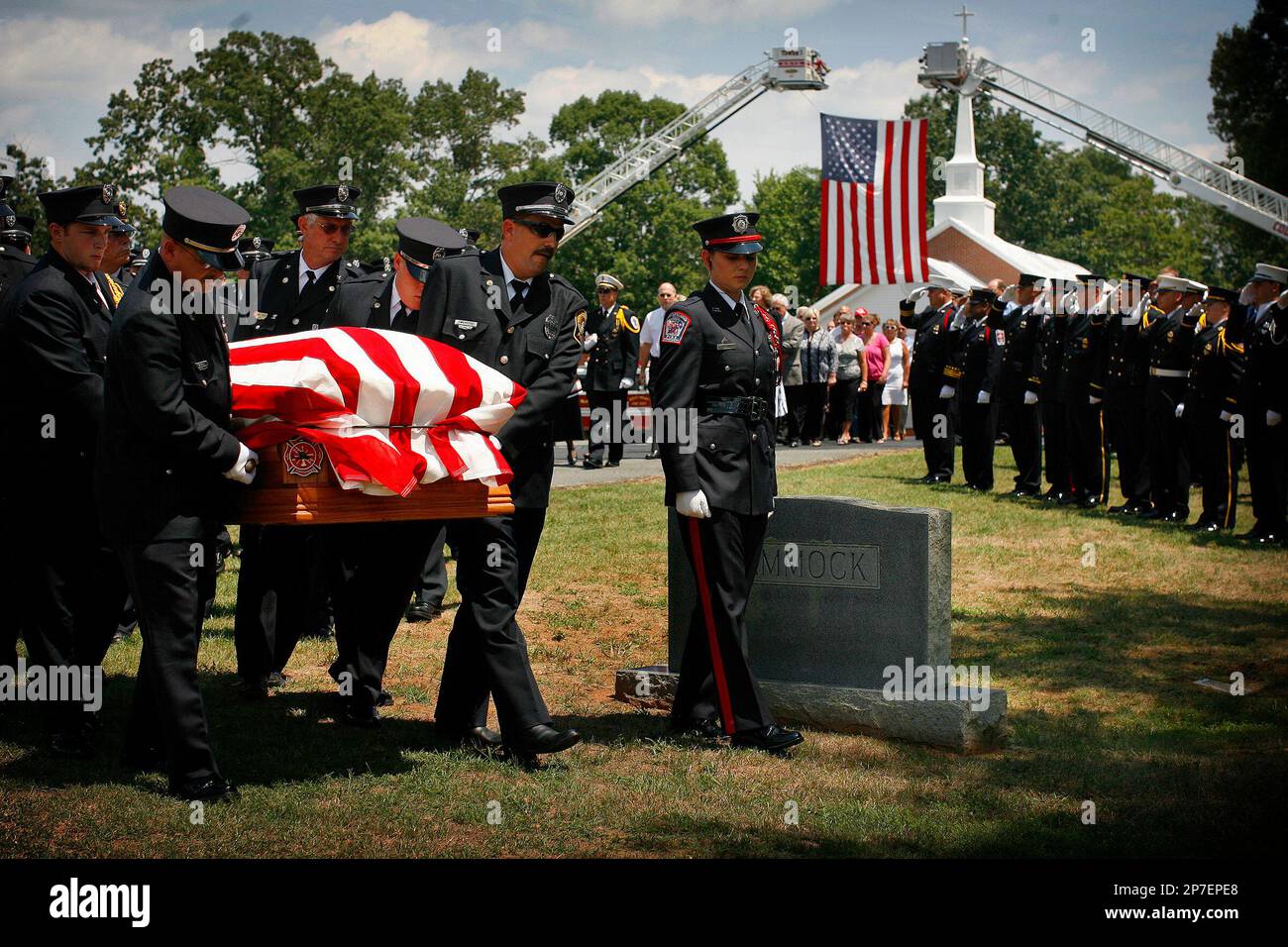 Pallbearers made up of fire and rescue officers carry the casket of ...