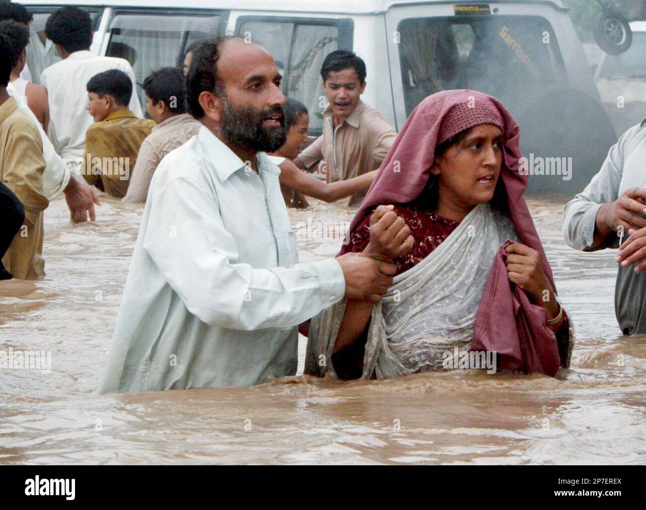 Pakistani villagers move into safe place from a flooded village near ...
