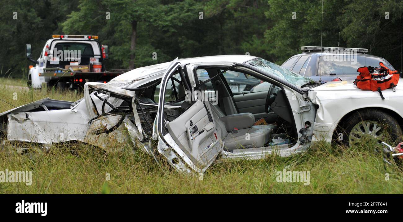 A Crown Victoria sits at the scene of a one-car accident on U.S. 49 ...