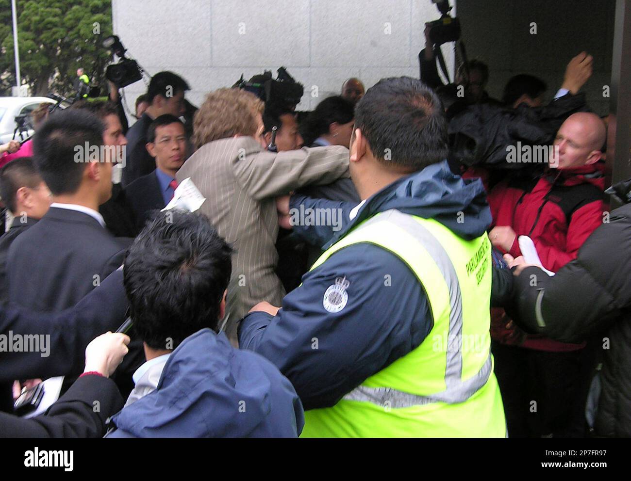 New Zealand Green Party co-leader Russel Norman, center, is held back ...
