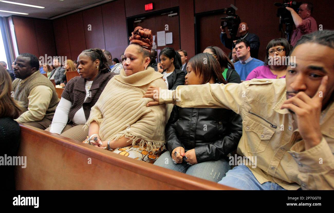 Coby Hightower, right, touches the arm of his mother, Shalga Hightower ...
