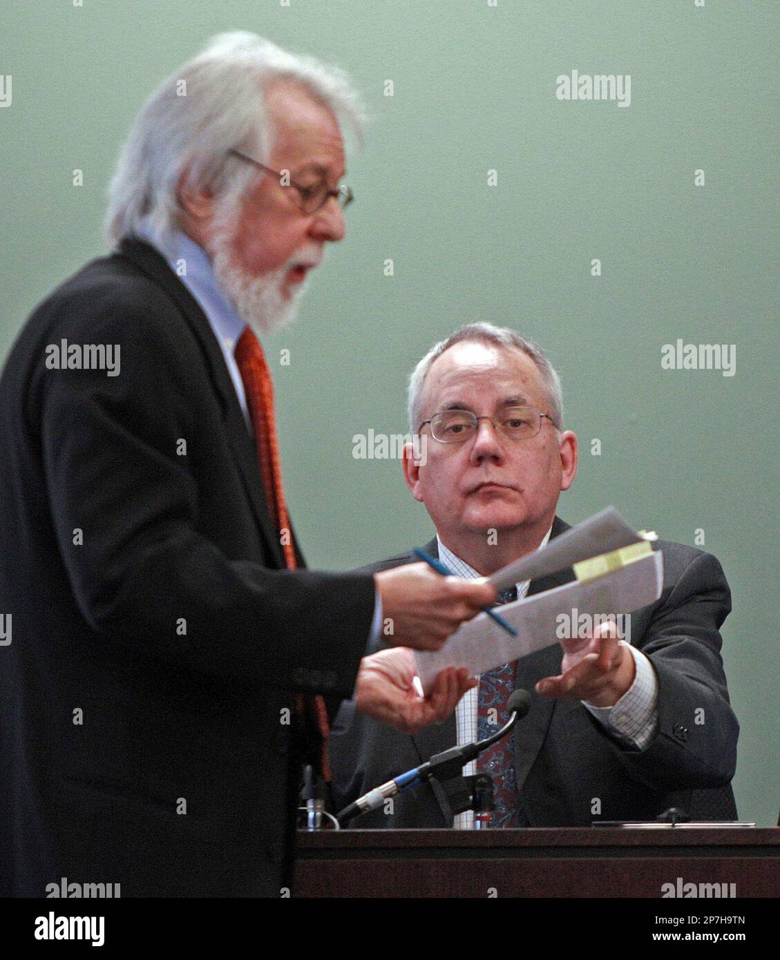 Defense attorney Joanathon Shapiro, left, hands John Odgren's medical ...