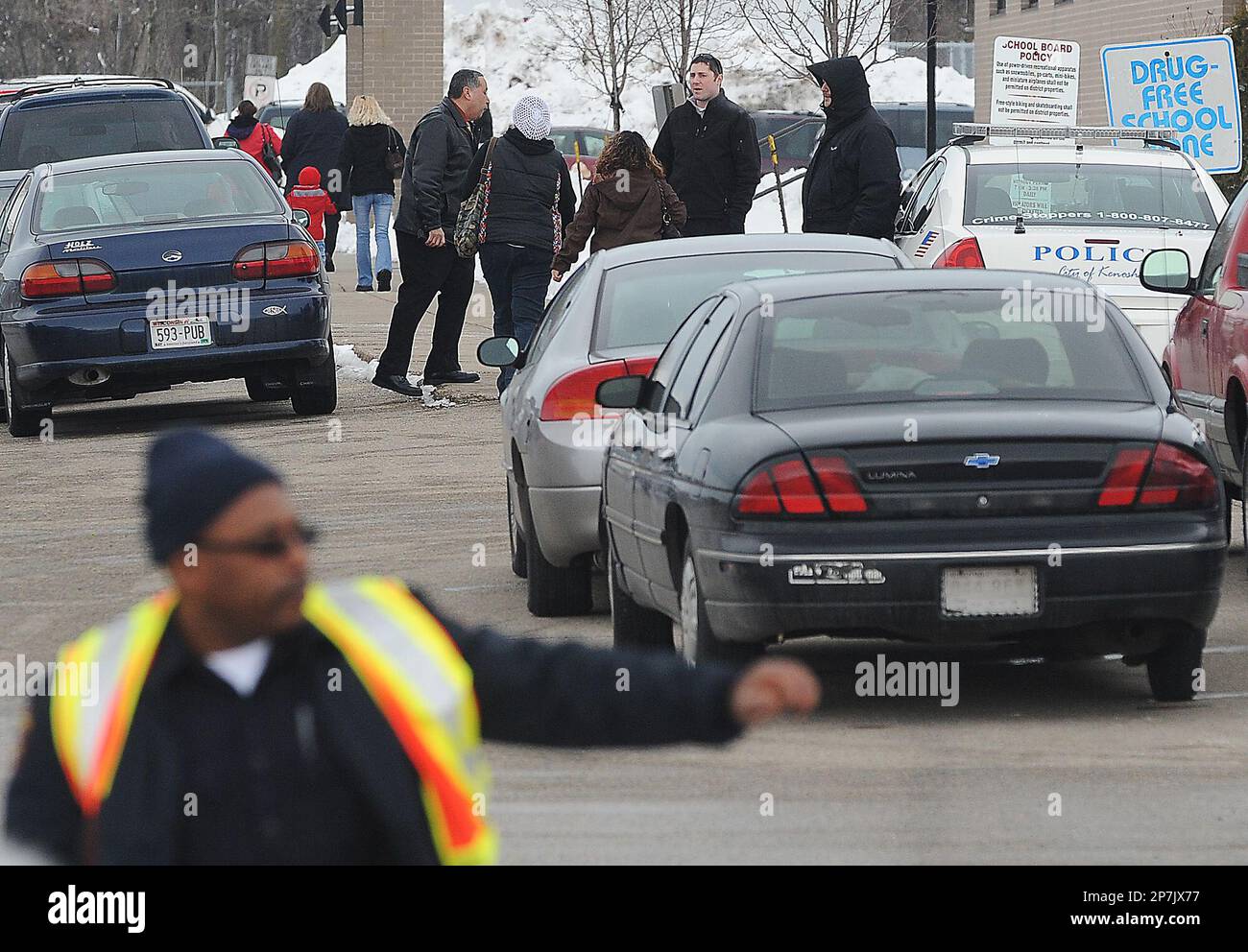 Parents arrive at a crowded Bradford High School parking lot to pick up ...