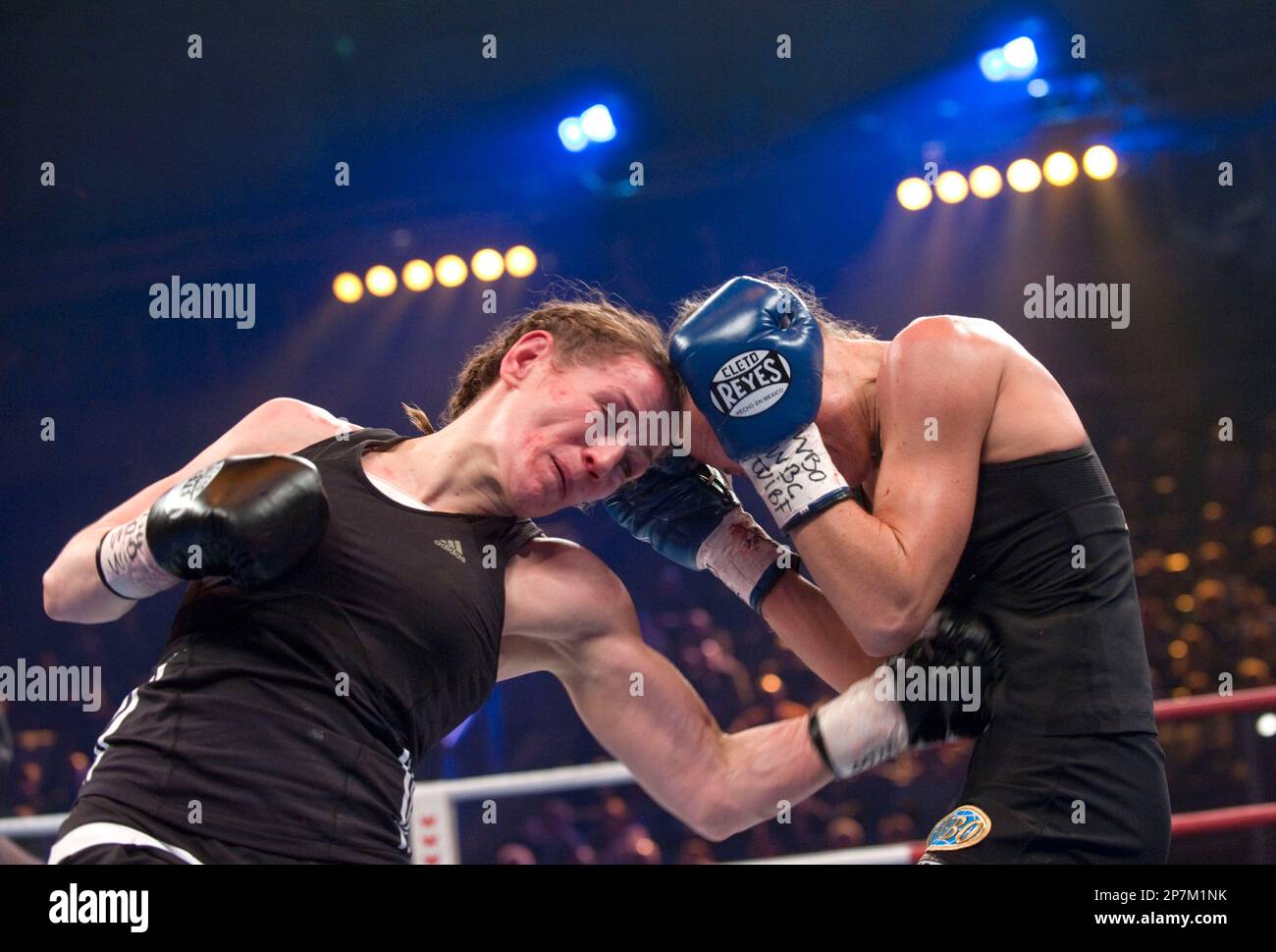 Germany's WIBF, WBC and WBO featherweight World champion Ina Menzer, left, lands a punch on her ...