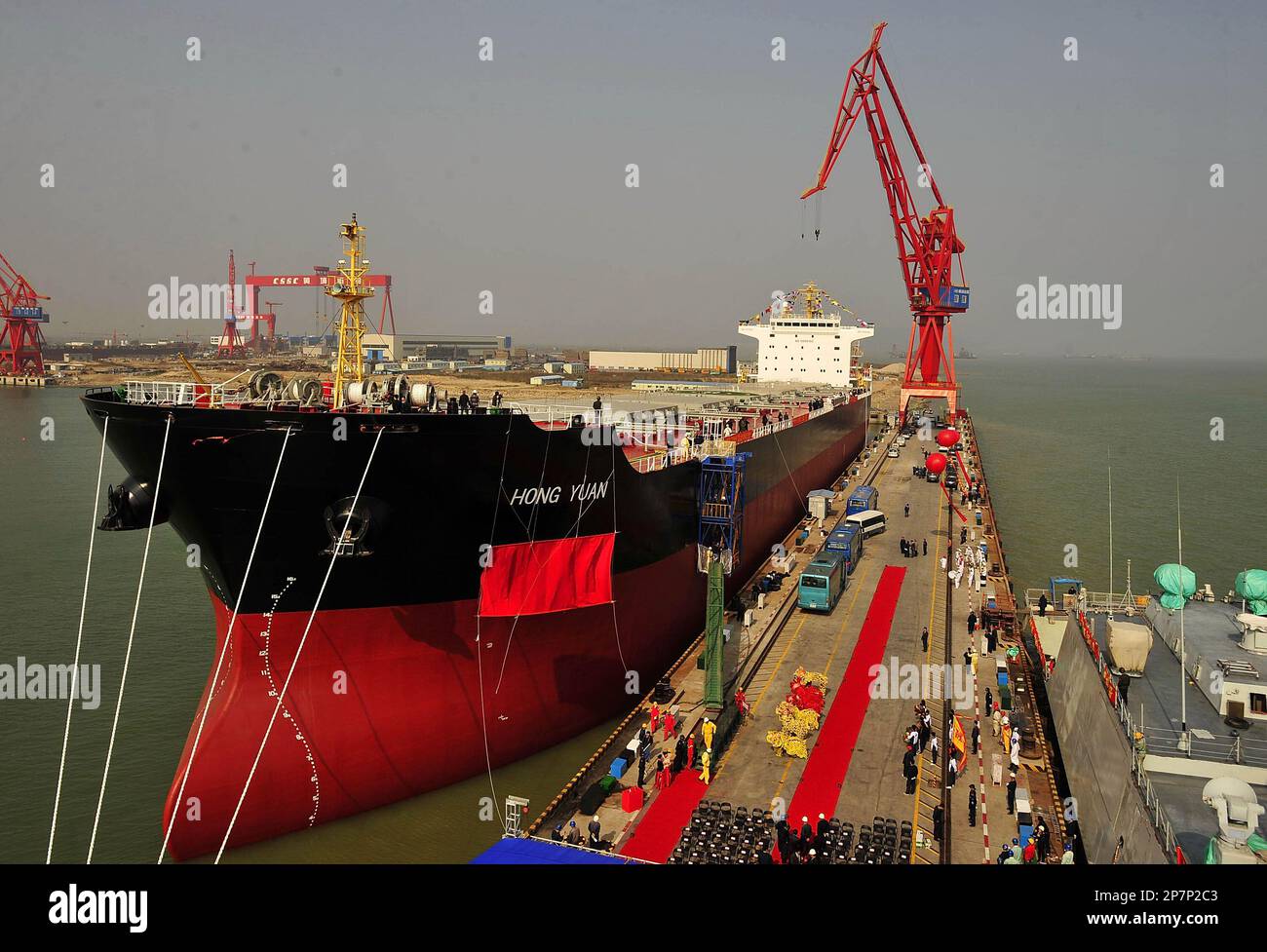 Workers celebrate during a handover ceremony of the 76,000-ton bulk ...
